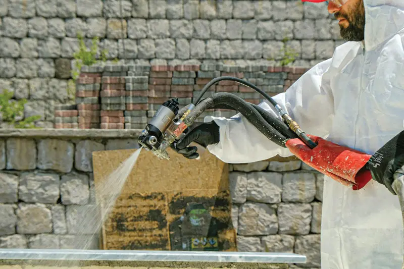 spraying-water-on-brick-wall - Construction Canada